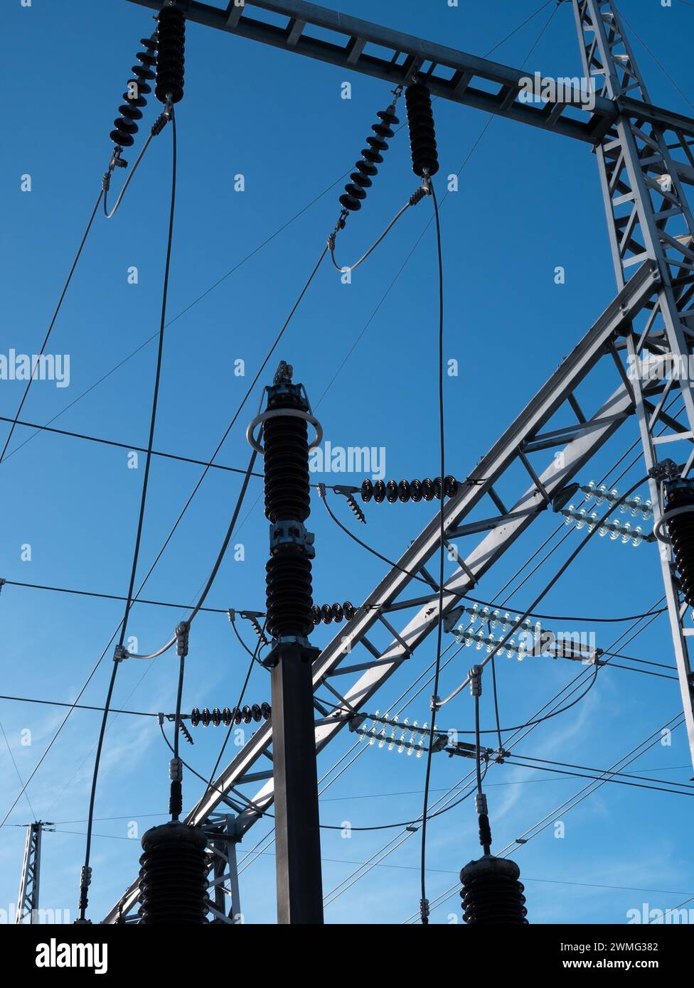 high-voltage power lines of transformer substation against the blue sky ...