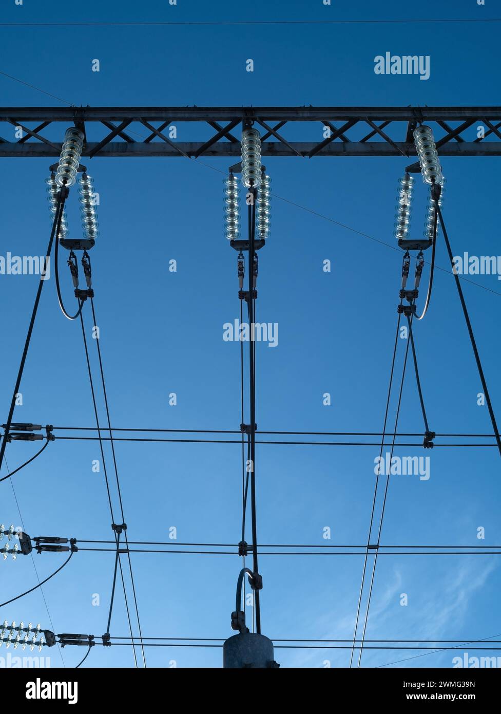 high-voltage power lines of transformer substation against the blue sky ...