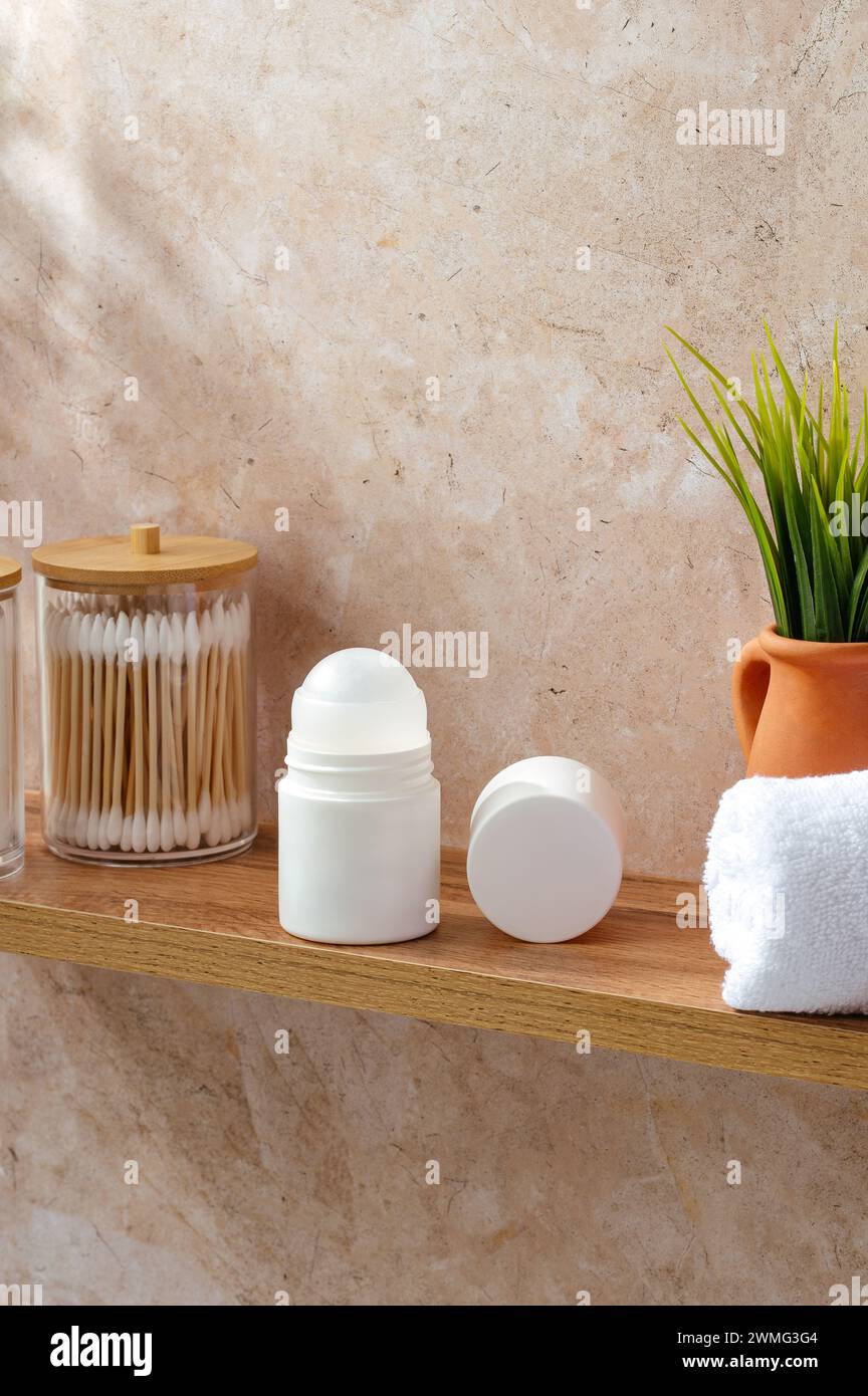 a mockup of a bottle of women's deodorant on a shelf in the bathroom ...
