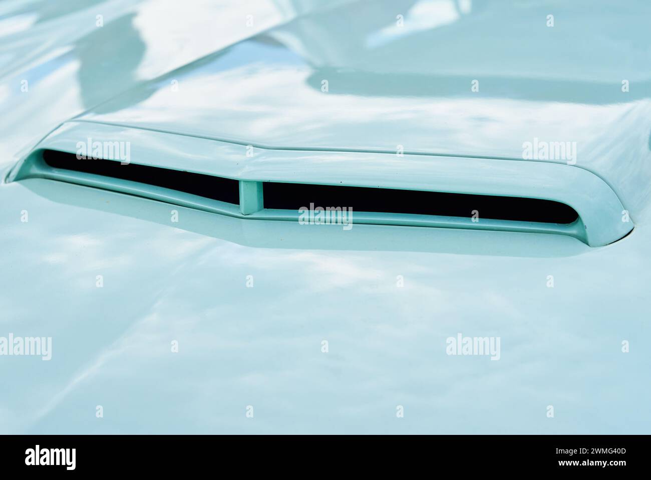 Close-up view of air intake vent on hood of retro sports car ...