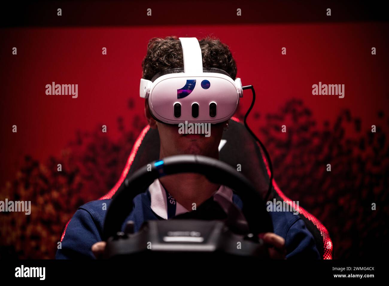 Barcelona, Spain. 26 Feb, 2024. A visitor experiences some immersive VR ...