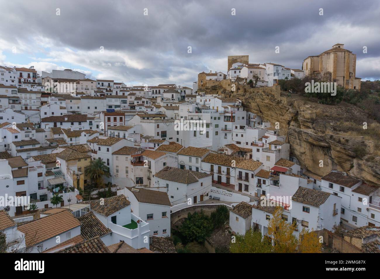 View over typical andalusian village with white houses and street with ...