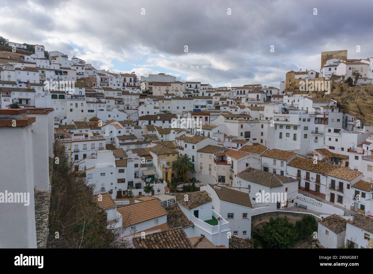 View over typical andalusian village with white houses and street with ...