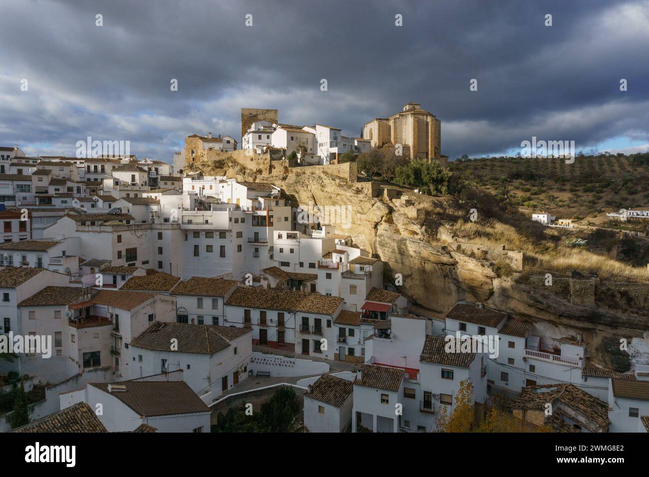 View over typical andalusian village with white houses and street with ...