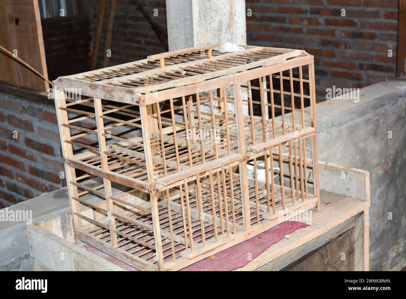 Red birdcage with open door. with a rural setting. low angle Stock ...