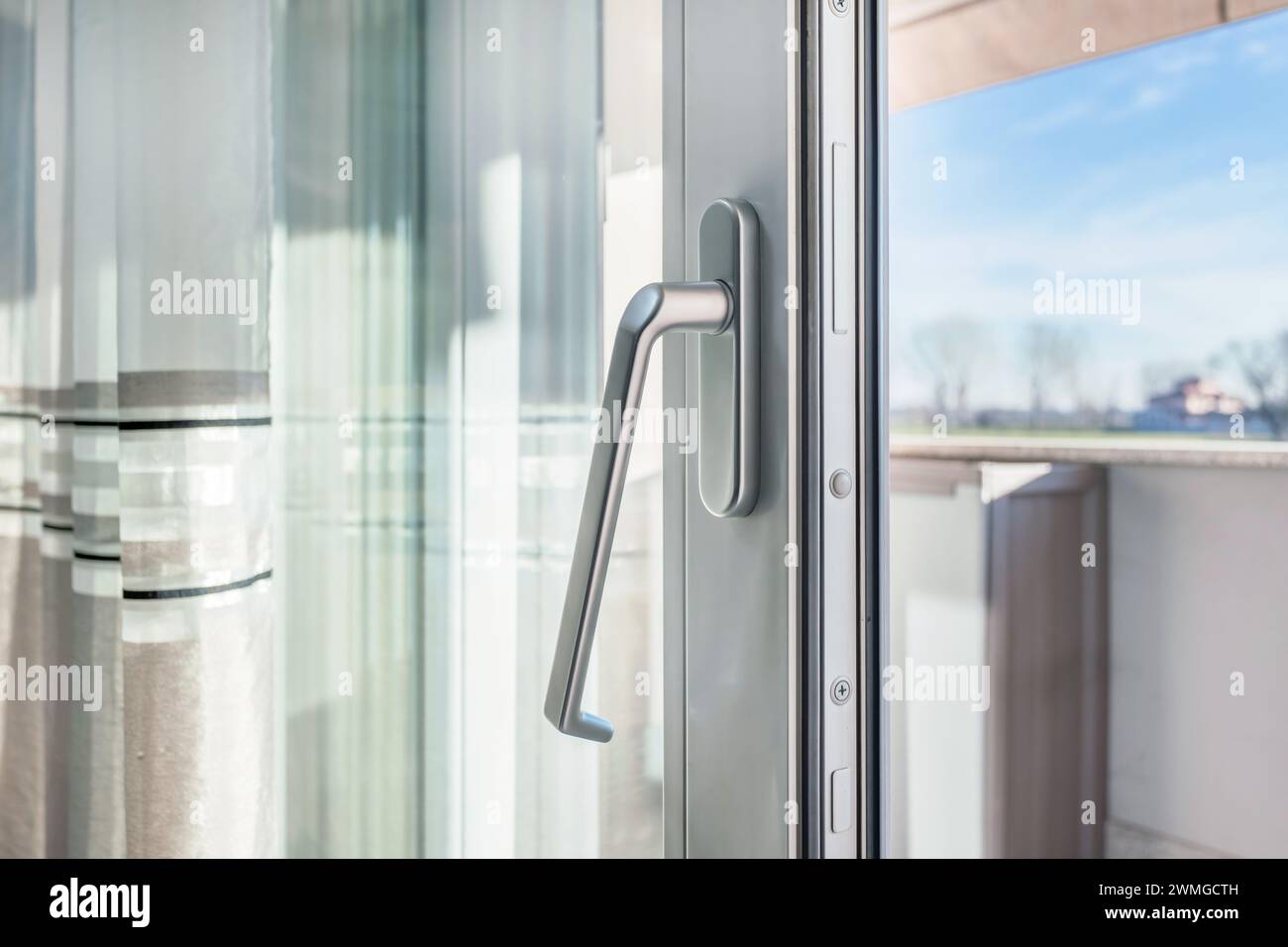 Closeup of PVC window with white metal frame and handle installed at ...