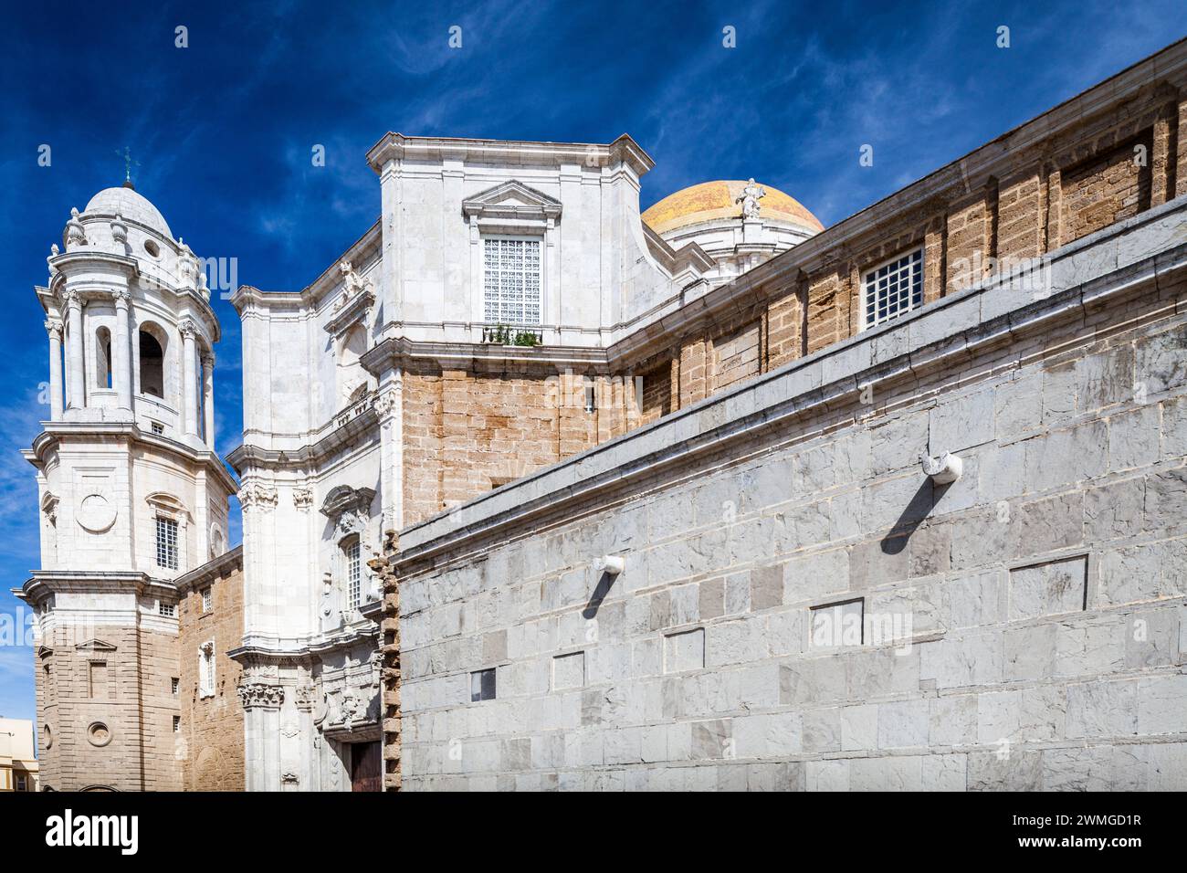 The Catedral de Cadiz stands majestic under a clear blue sky. Sunlight ...