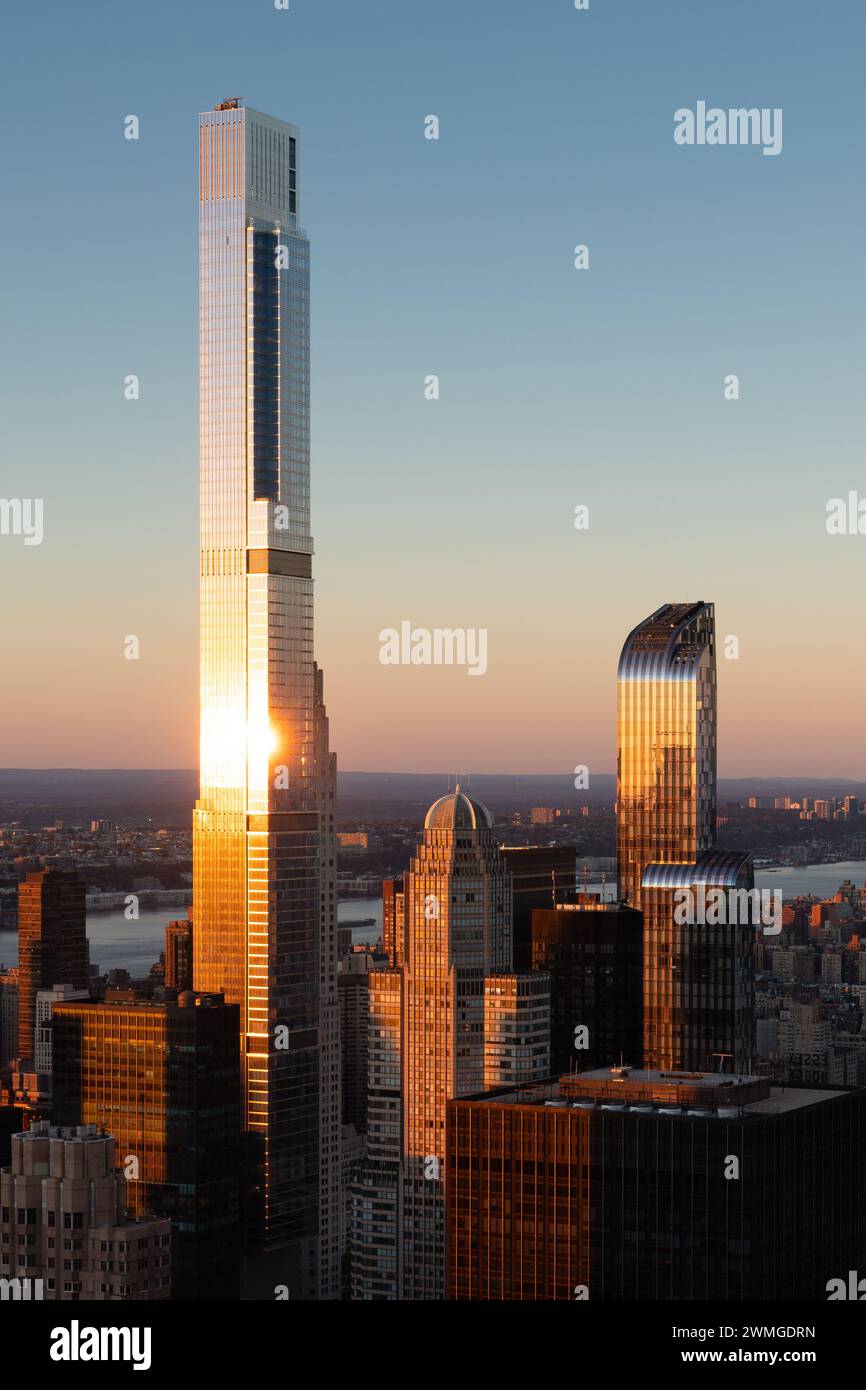 New York City, Central Park Tower and reflected light at sunset. Aerial view of supertall ...