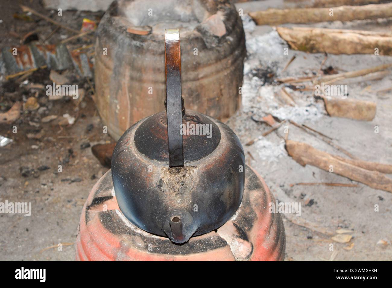 Still life typical Indonesian traditional teapot. Against a red brick ...
