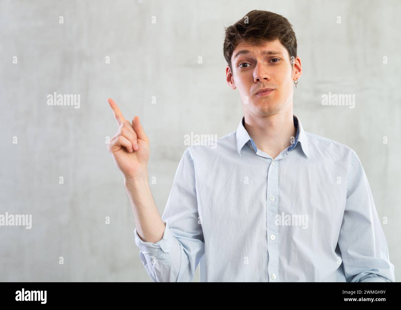 Positive man pointing with his hand at something - advertising concept ...
