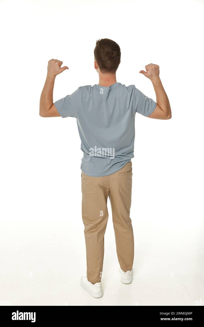 happy guy looking pointing to his back on white studio background Stock ...