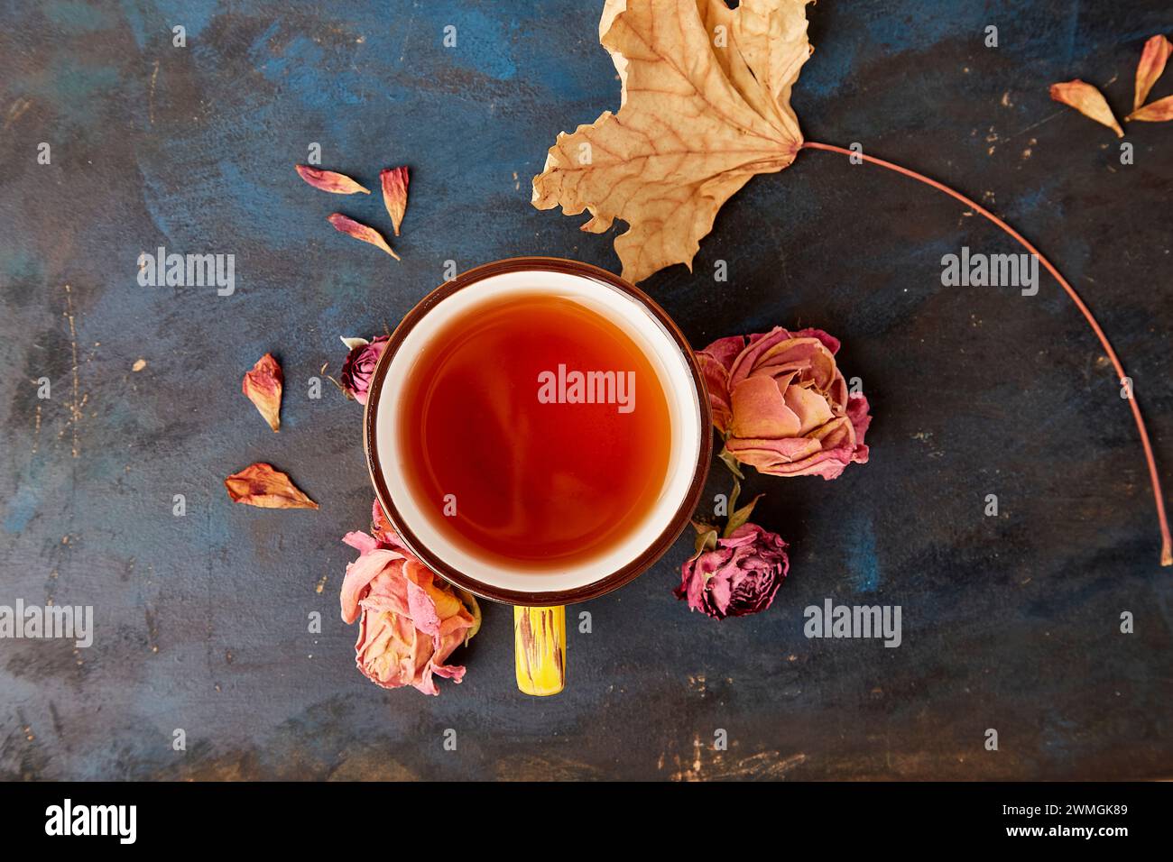 Autumn-Inspired hot autumn tea cup among dry roses. Aesthetic fall ...