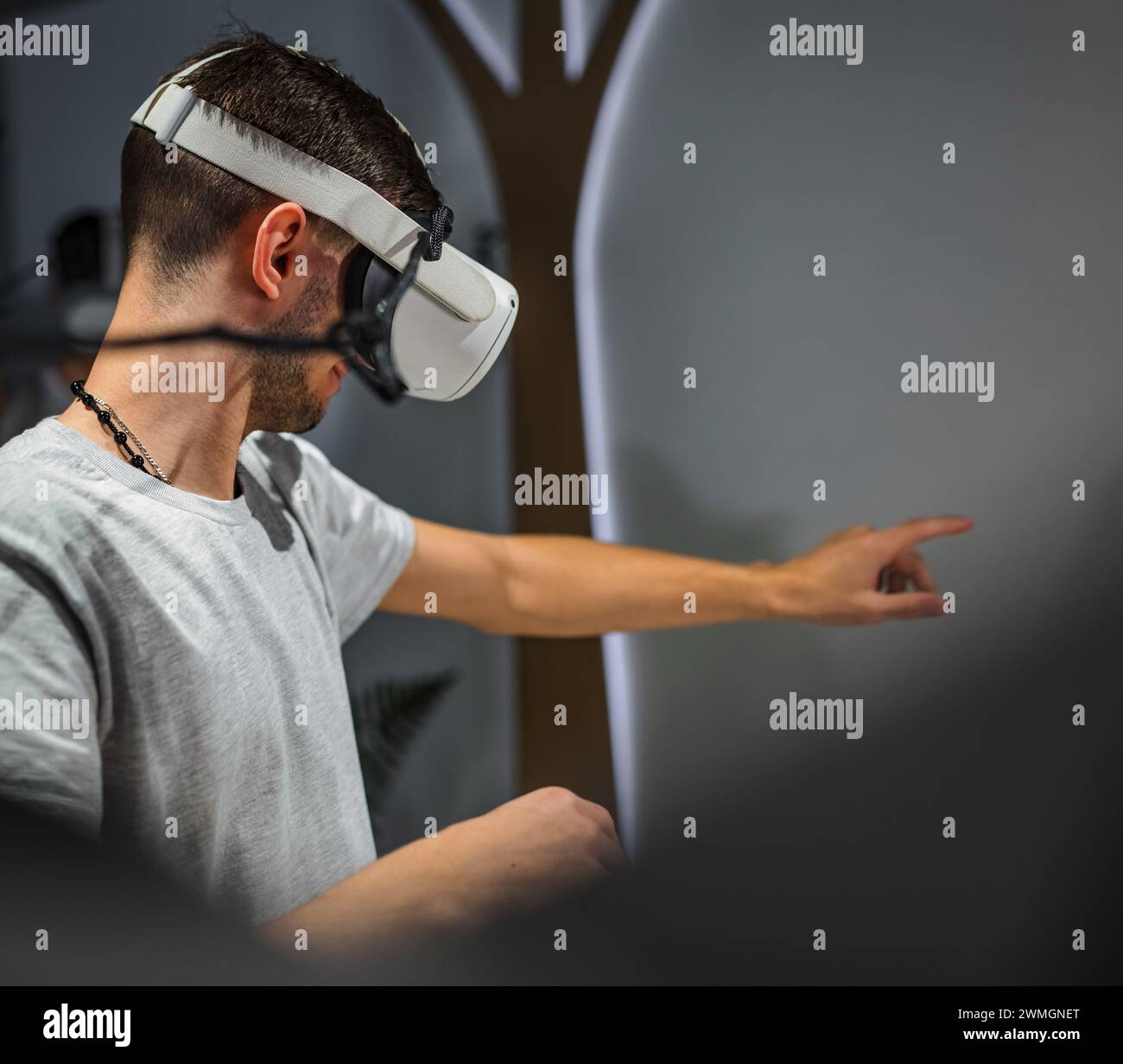 Teen man having fun in the natural history museum VR room, using ...