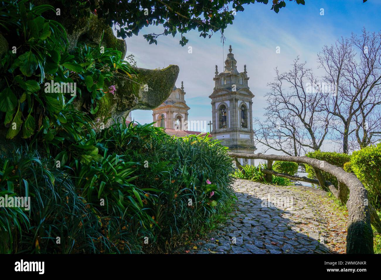 A stone path leading to a charming church with a steeple, inviting you ...
