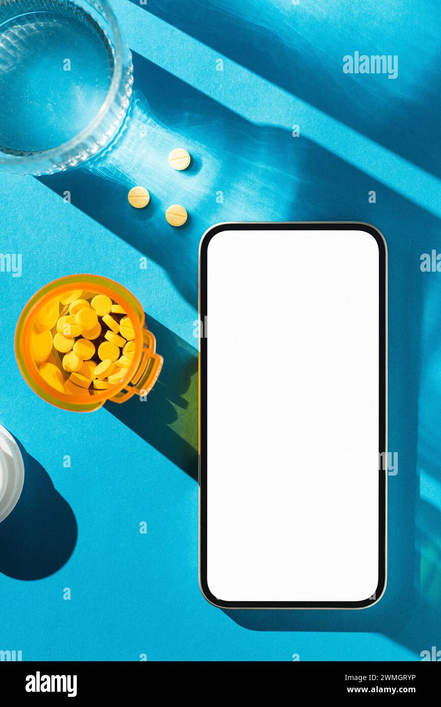 Smart phone mockup with blank screen on blue background with bottle of ...