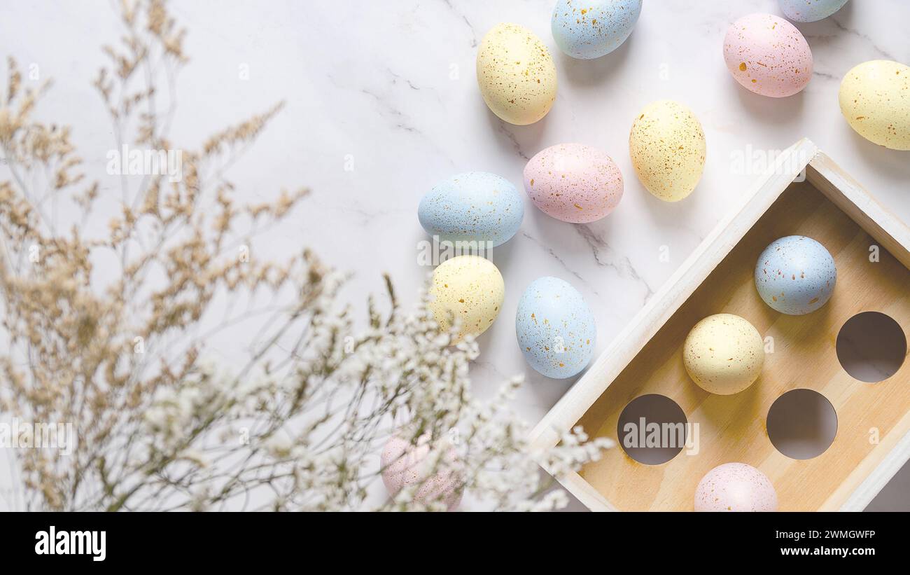Colorful Easter eggs with golden spots in a wooden box on a white ...
