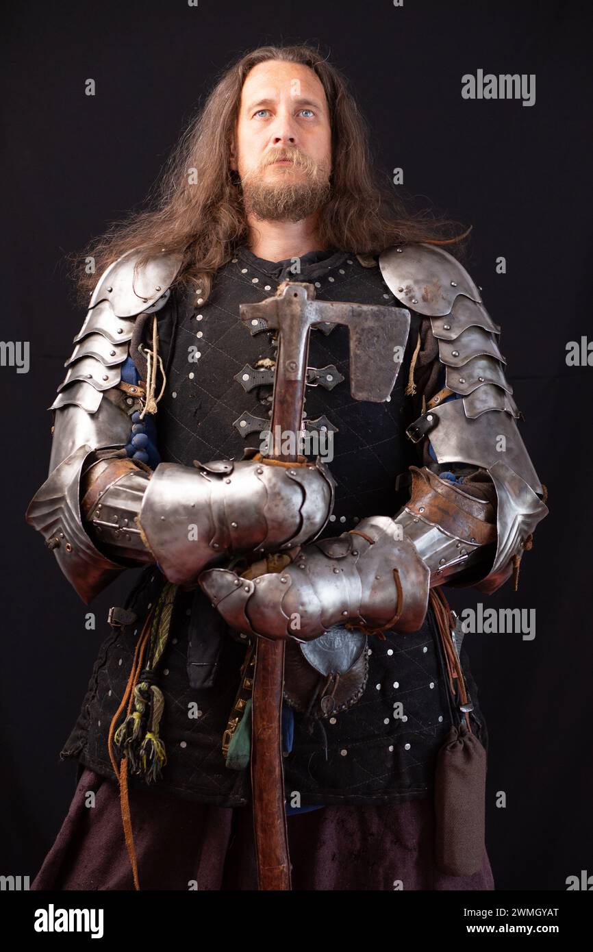 Vertical composition. Portrait of a medieval knight with long hair with ...