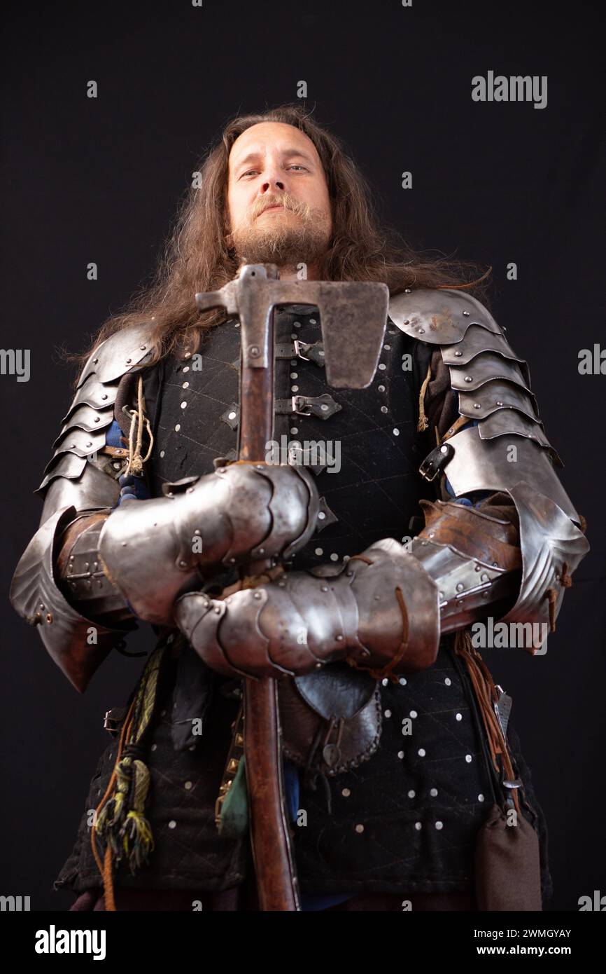 Vertical composition. Portrait of a medieval knight with long hair with ...