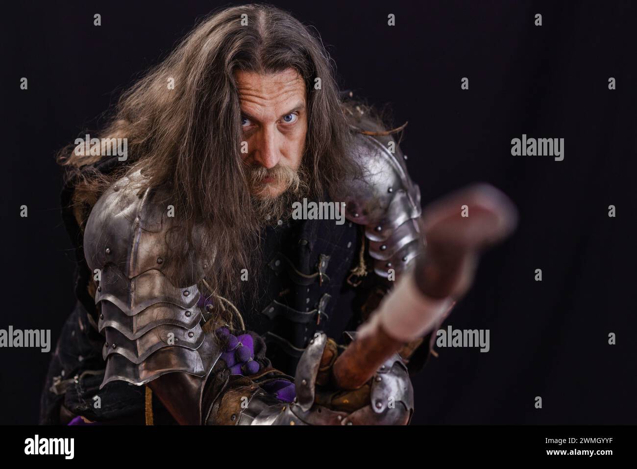 A medieval knight in armor strikes. Charismatic actor with mustache and ...