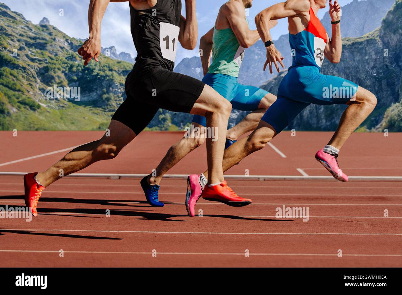 group male athletes running on red track stadium on background ...