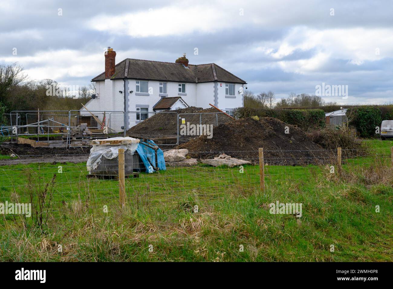 Large white house in a countryside setting undergoing major ...