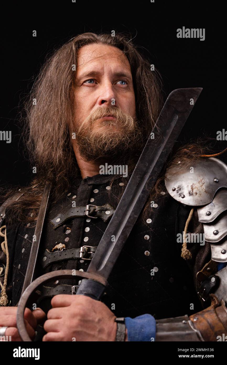 Vertical composition. Close-up portrait of a medieval knight with two ...