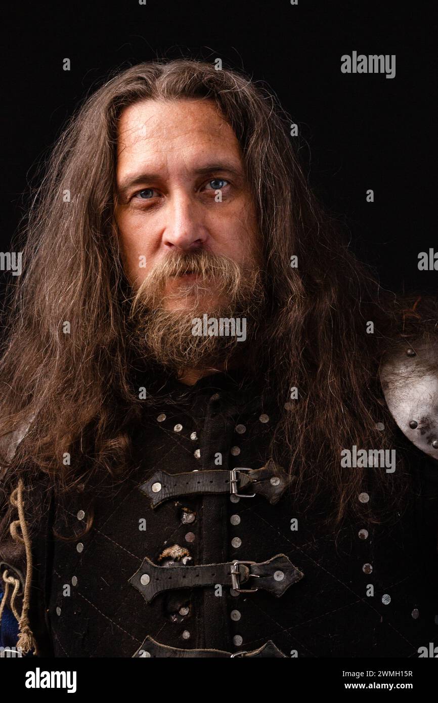 Vertical composition. Close-up portrait of a medieval knight with a ...