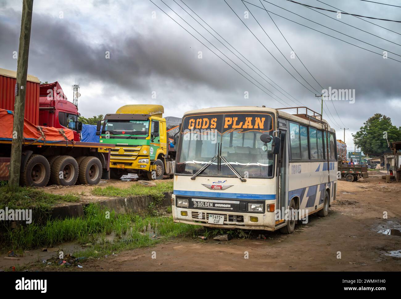 A bus with "Gods Plan" on the windscreen at a truck stop on the main A7 ...
