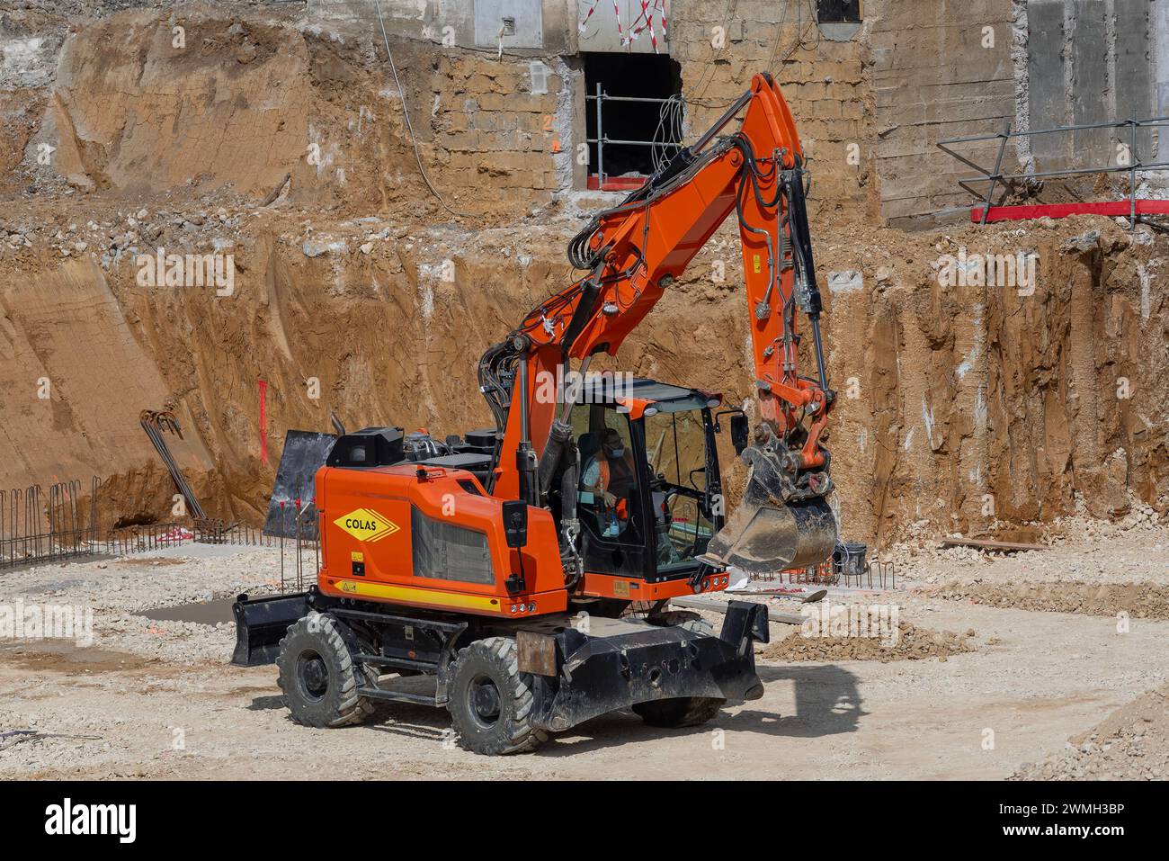 Nancy, France - Orange wheeled excavator CAT M317F for earthwork on a ...