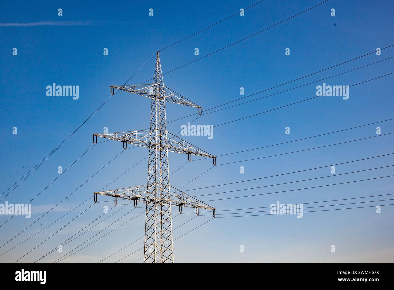 electrical tower in field under clear blue sky Stock Photo - Alamy