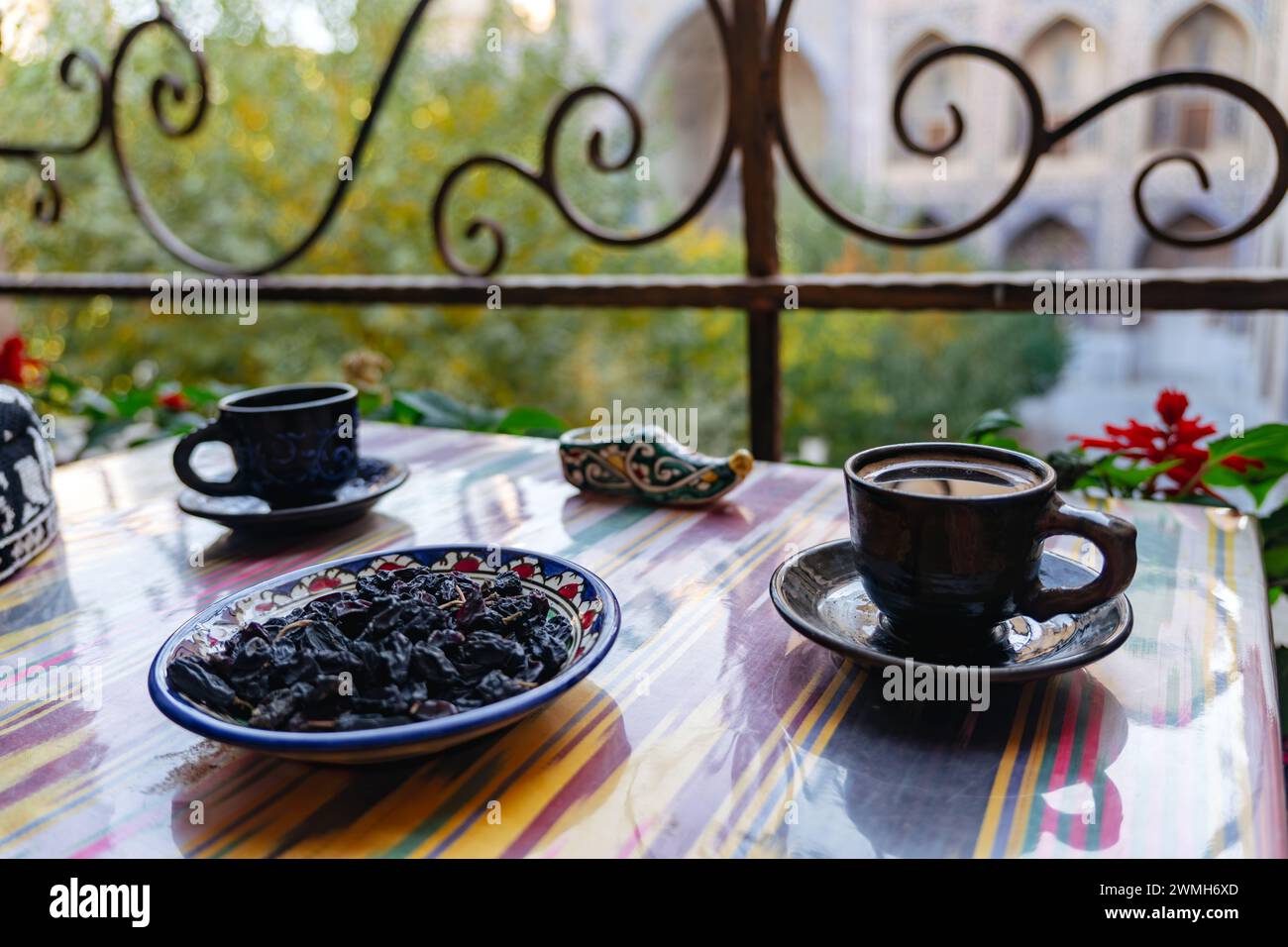 a black mug on the table against the background of beautiful medieval ...