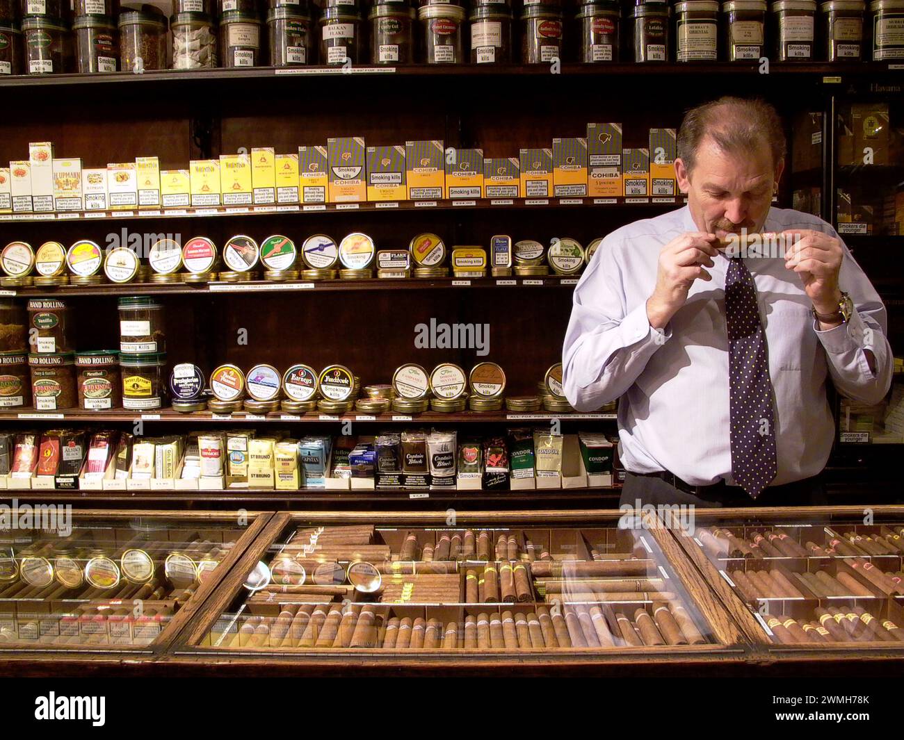 James J. Fox oldest cigar merchant in the world . Man is sniff at a ...