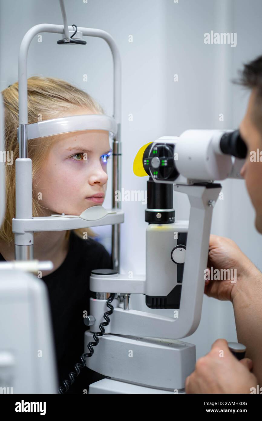 doctor and young patient in eye clinic, girl undergoing an eye test ...