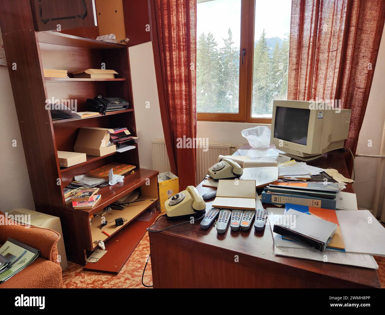Desk with laptop and personal items scattered on it Stock Photo - Alamy