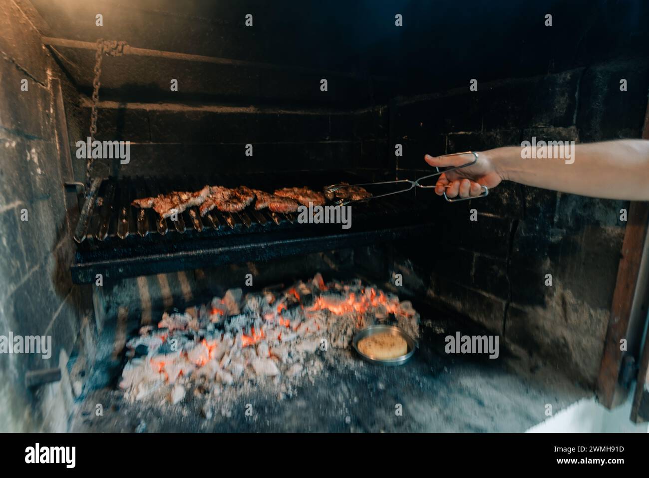Typical Argentinian barbecue or asado. hand Stock Photo - Alamy