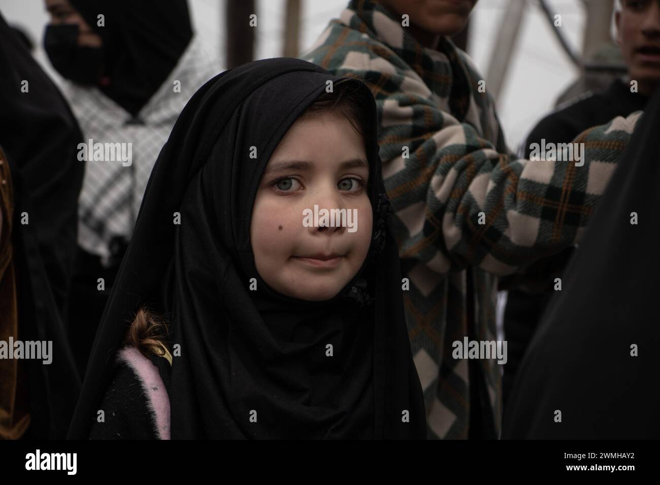 Budgam, Jammu And Kashmir, India. 26th Feb, 2024. A Shia girl looks on ...