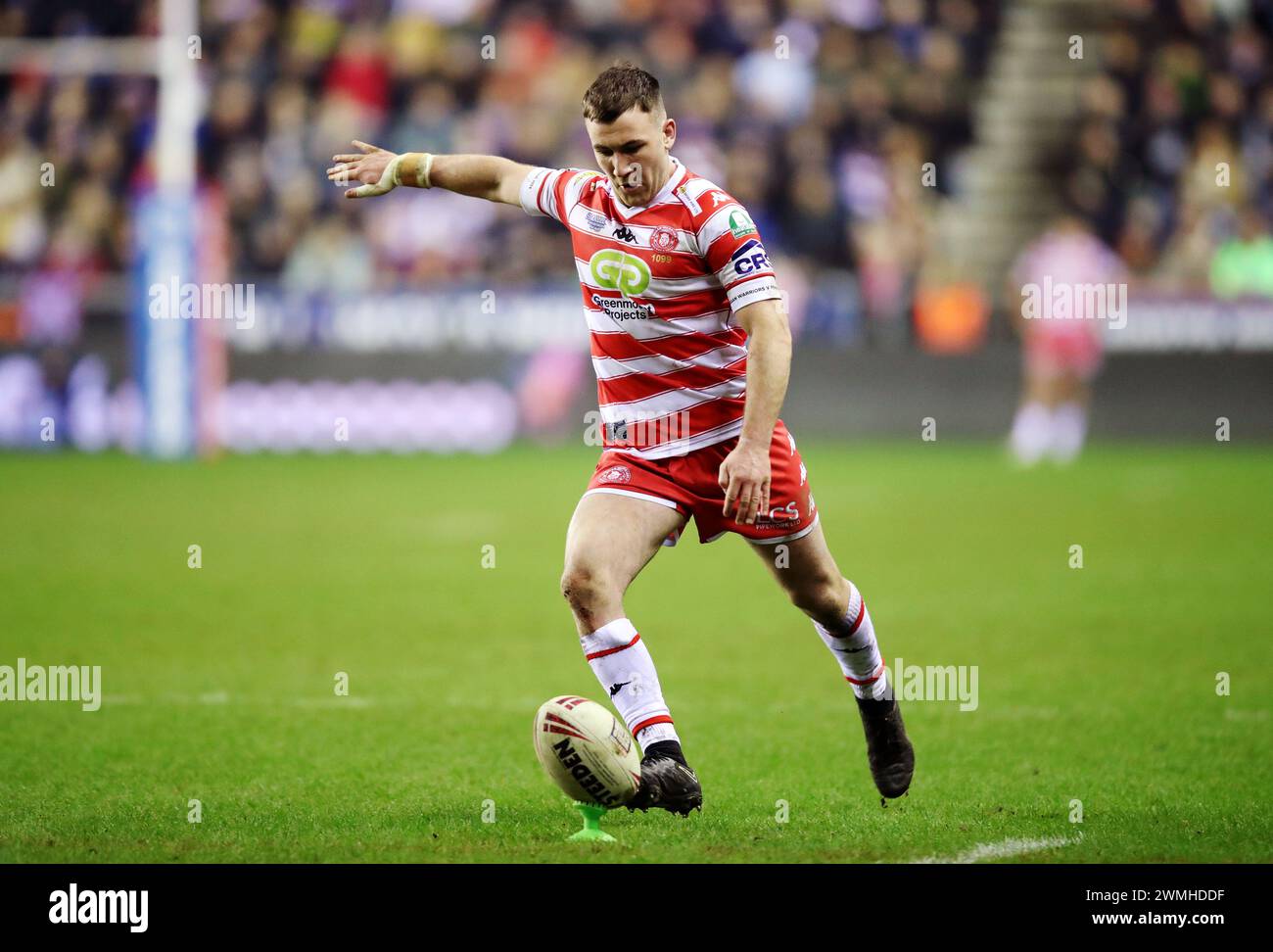 Wigan Warriors' Harry Smith kicks a conversion after teammate Jake ...