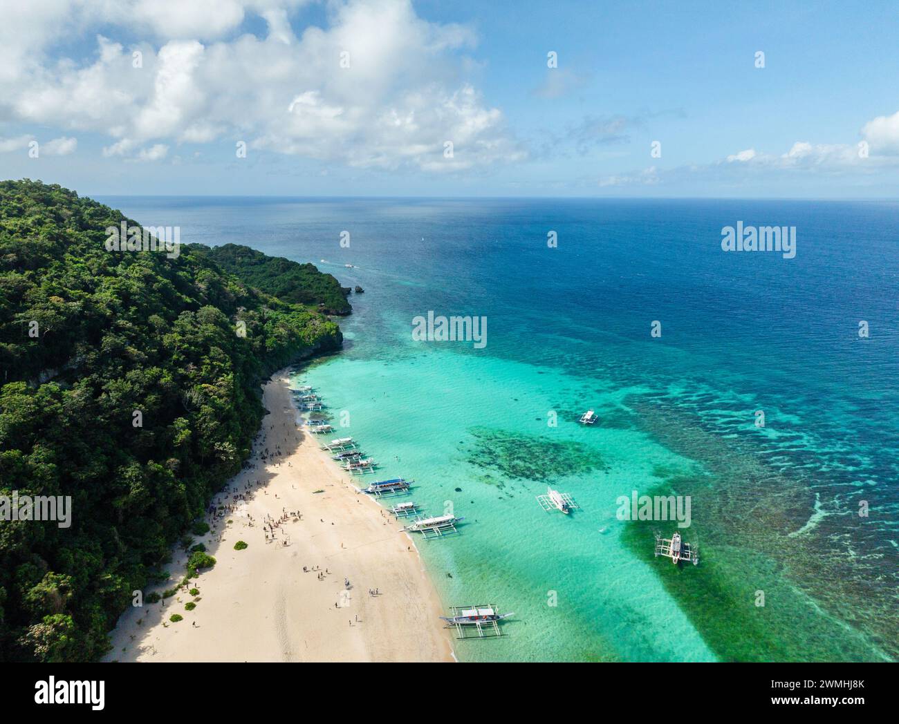 Ocean waves on white sand, boats floating over clear turquoise water ...