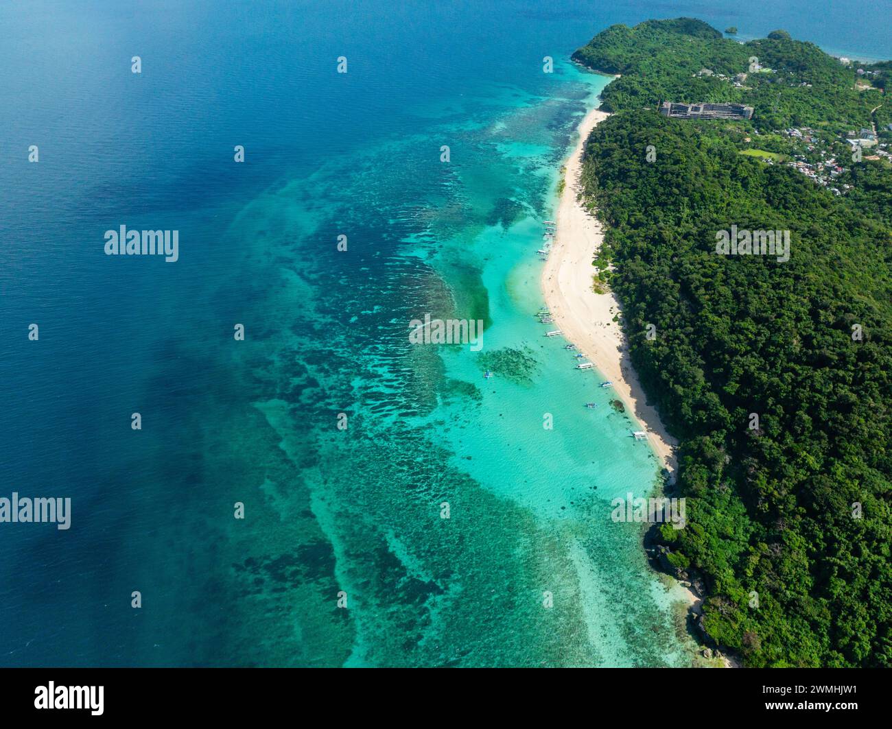 Transparent turquoise sea waters with coral reefs in Puka Shell Beach ...
