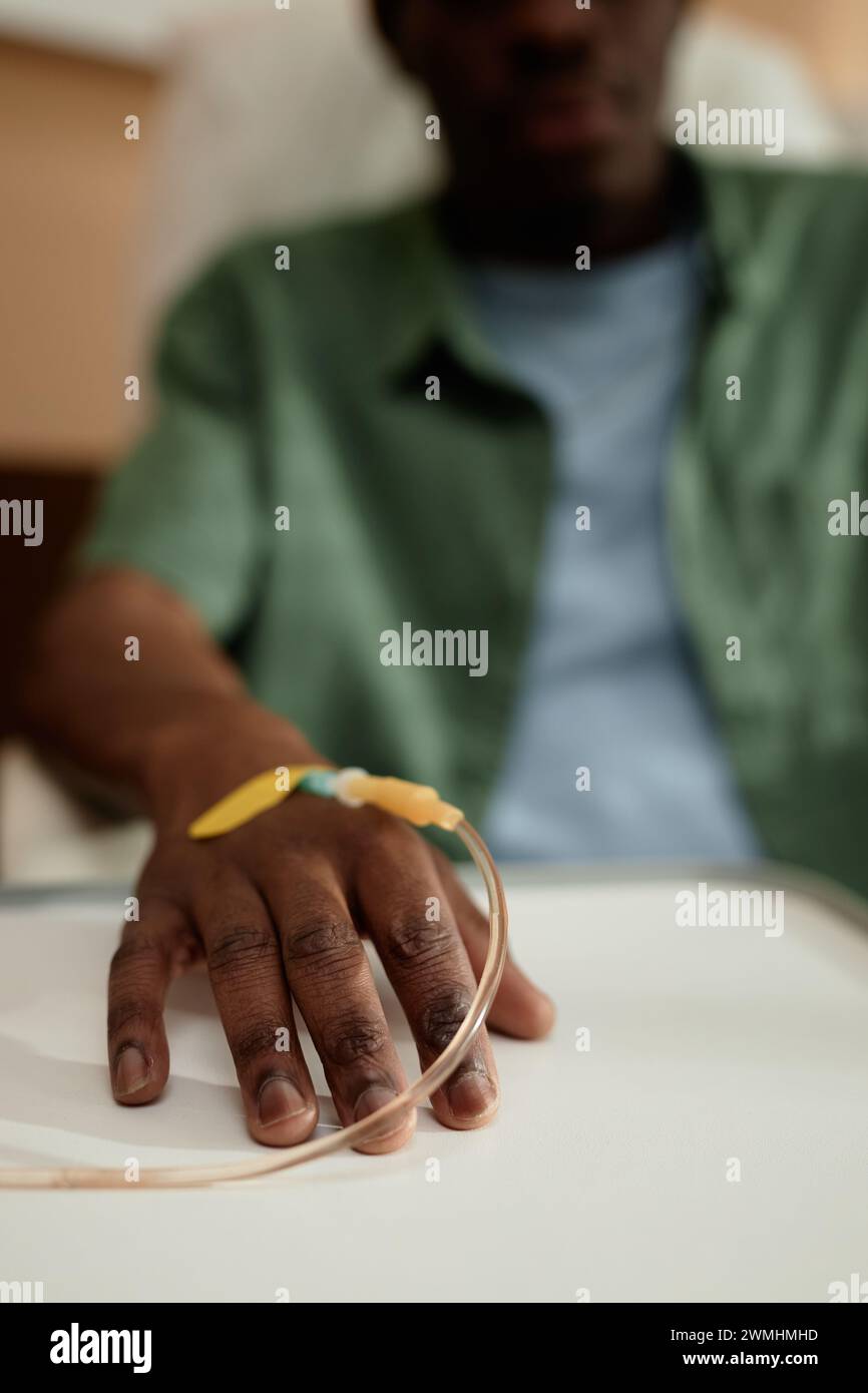 Vertical close up of Black man receiving treatment in hospital focus on ...