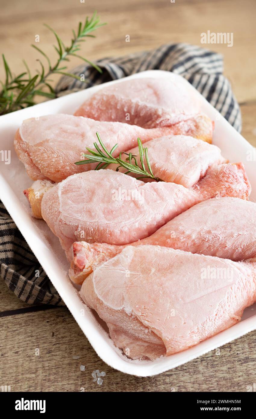 Frozen chicken thighs in a styrofoam tray Stock Photo - Alamy
