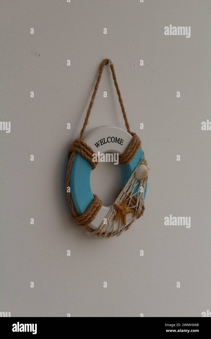 One white and teal float beach welcome sign decoration hanging from ...