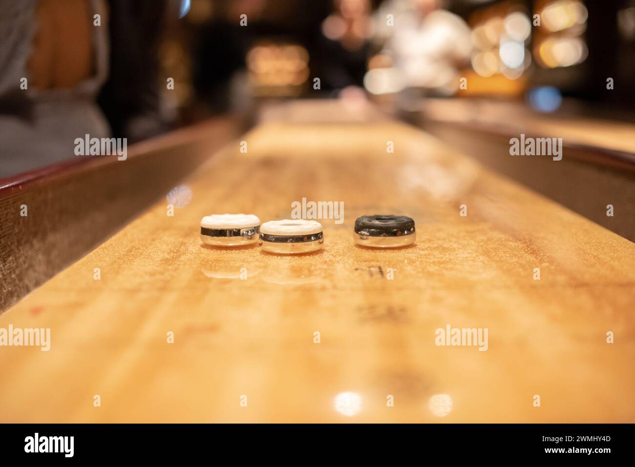 Playing the game of shuflleboard Stock Photo - Alamy