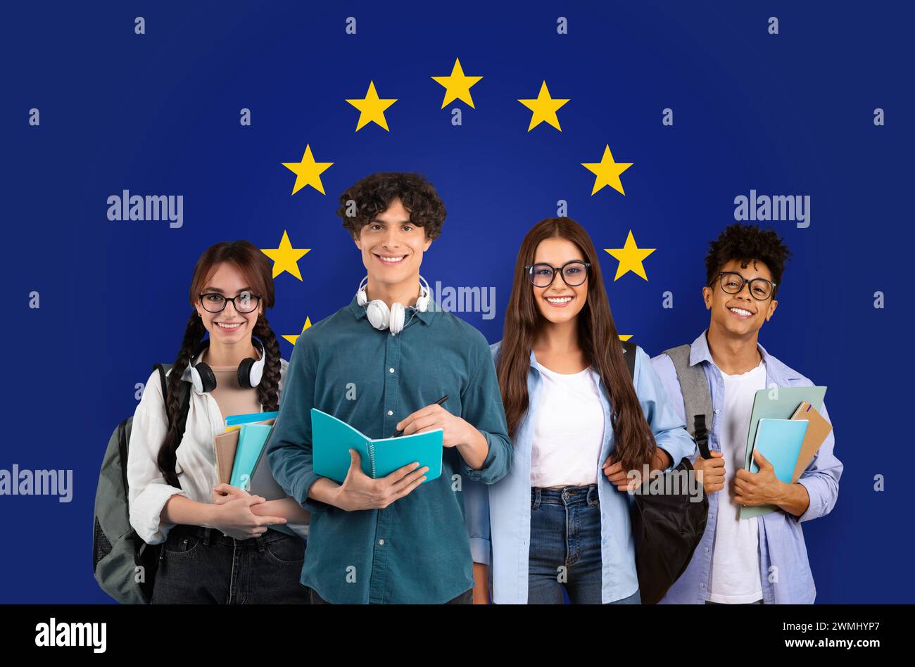 Four cheerful students with backpacks and notebooks standing against a ...