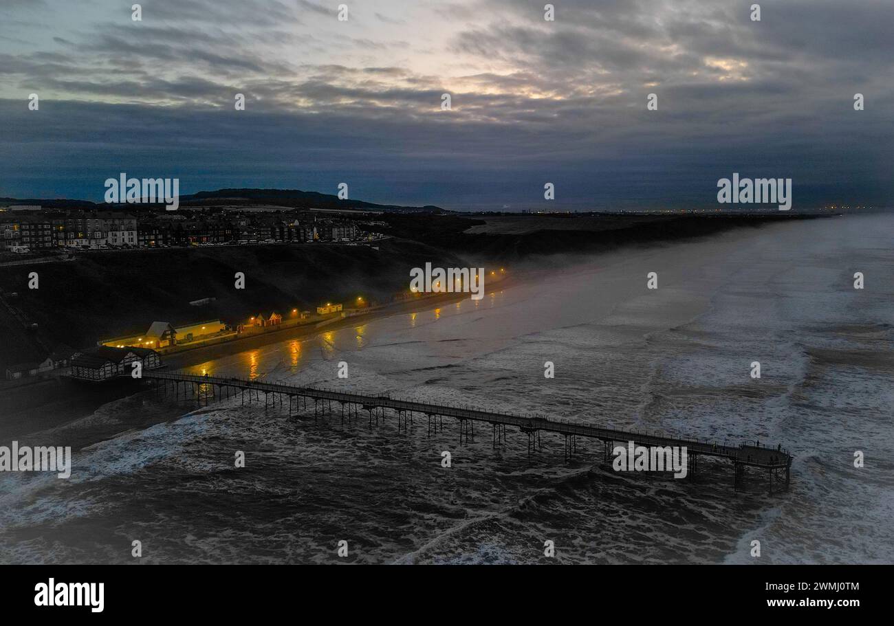 A beach at night with illuminated lights on the shore Stock Photo - Alamy