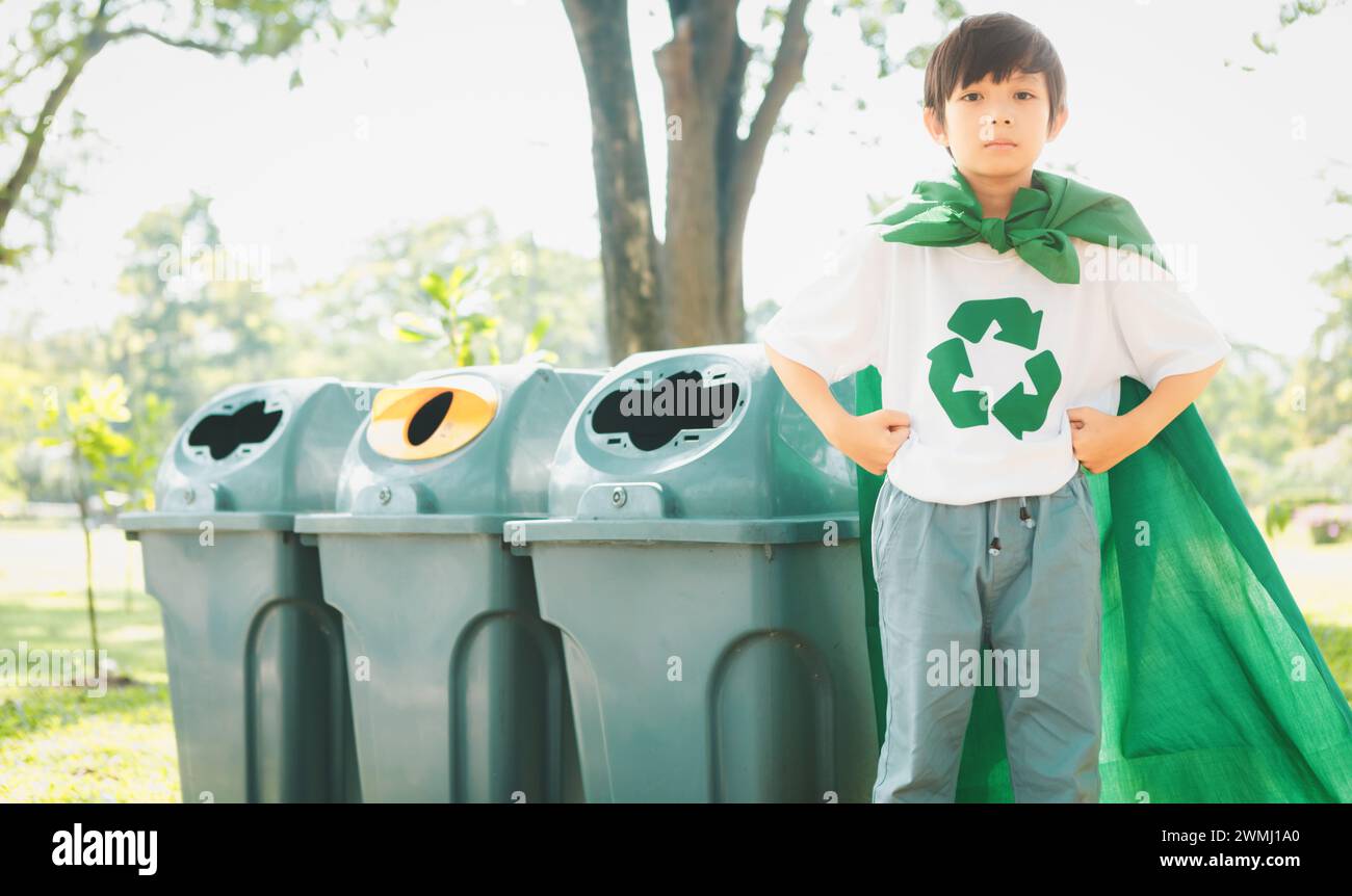 Cheerful young superhero boy with cape and recycle symbol promoting ...