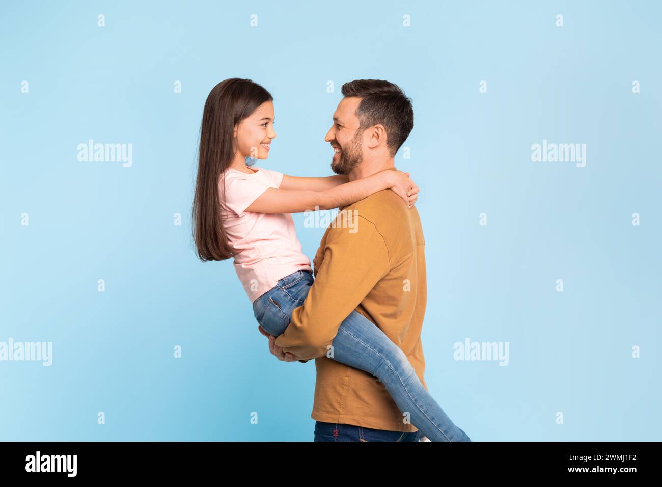 Happy Father Carrying His Little Daughter In Hug, Studio Stock Photo - Alamy