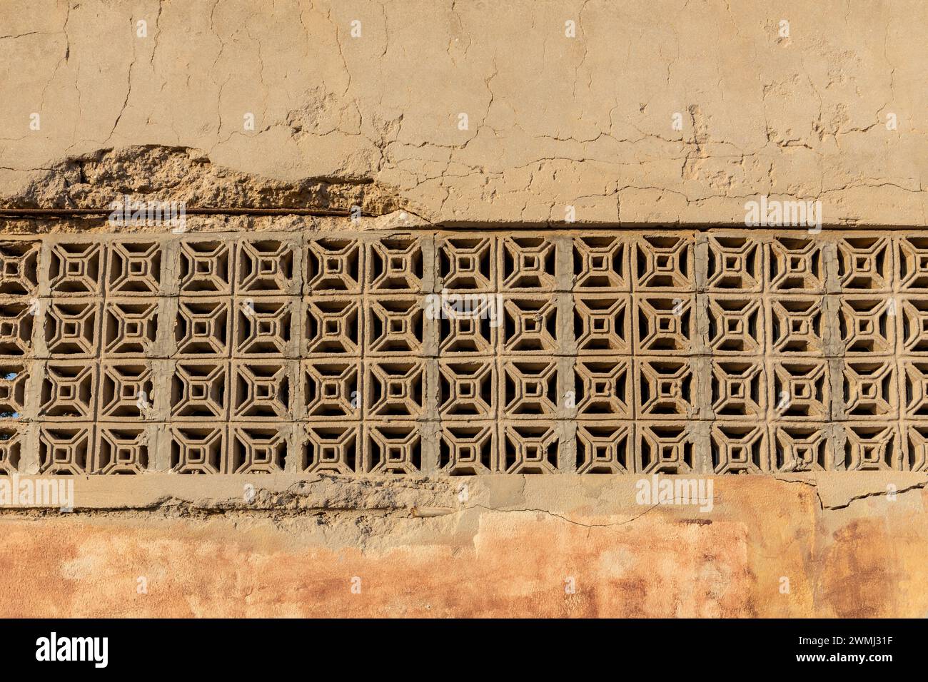 Old stone wall with openwork arabic ornaments in Al Jazirah Al Hamra ...