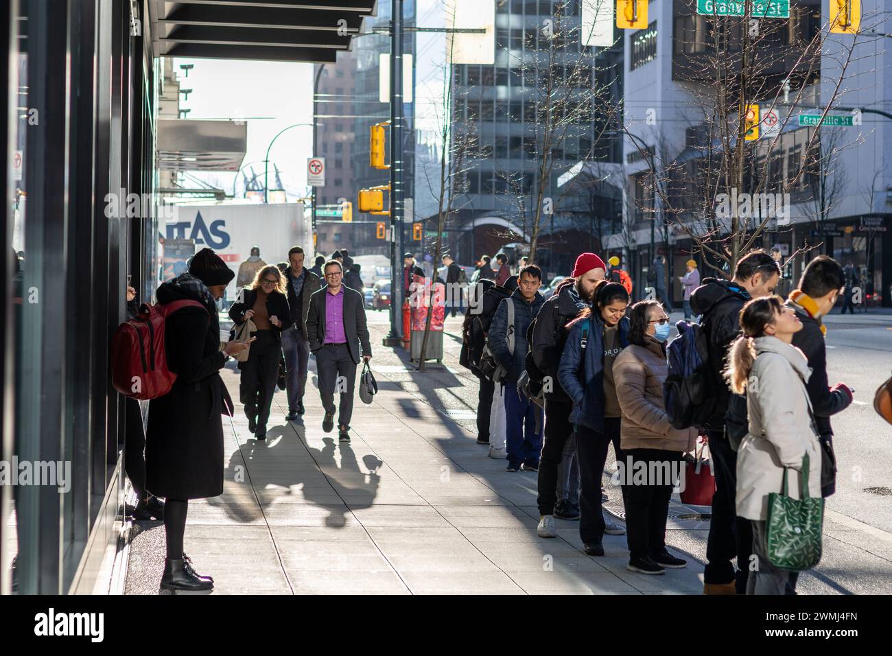 A view of the sidewalk of Georgia Street looking east, showing people ...