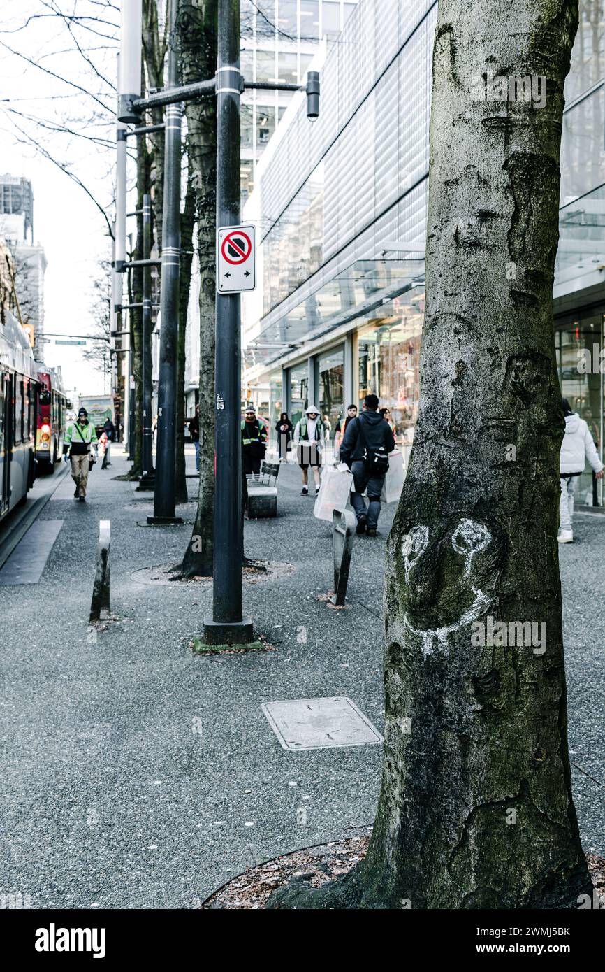 A photo of a tree with a painted smiling and weeping face on Granville ...